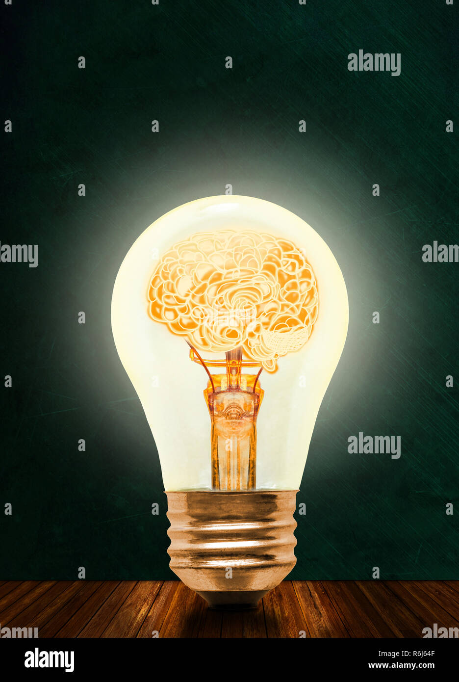 Anatomy of a human brain glowing inside illuminated light bulb with blackboard background and ...