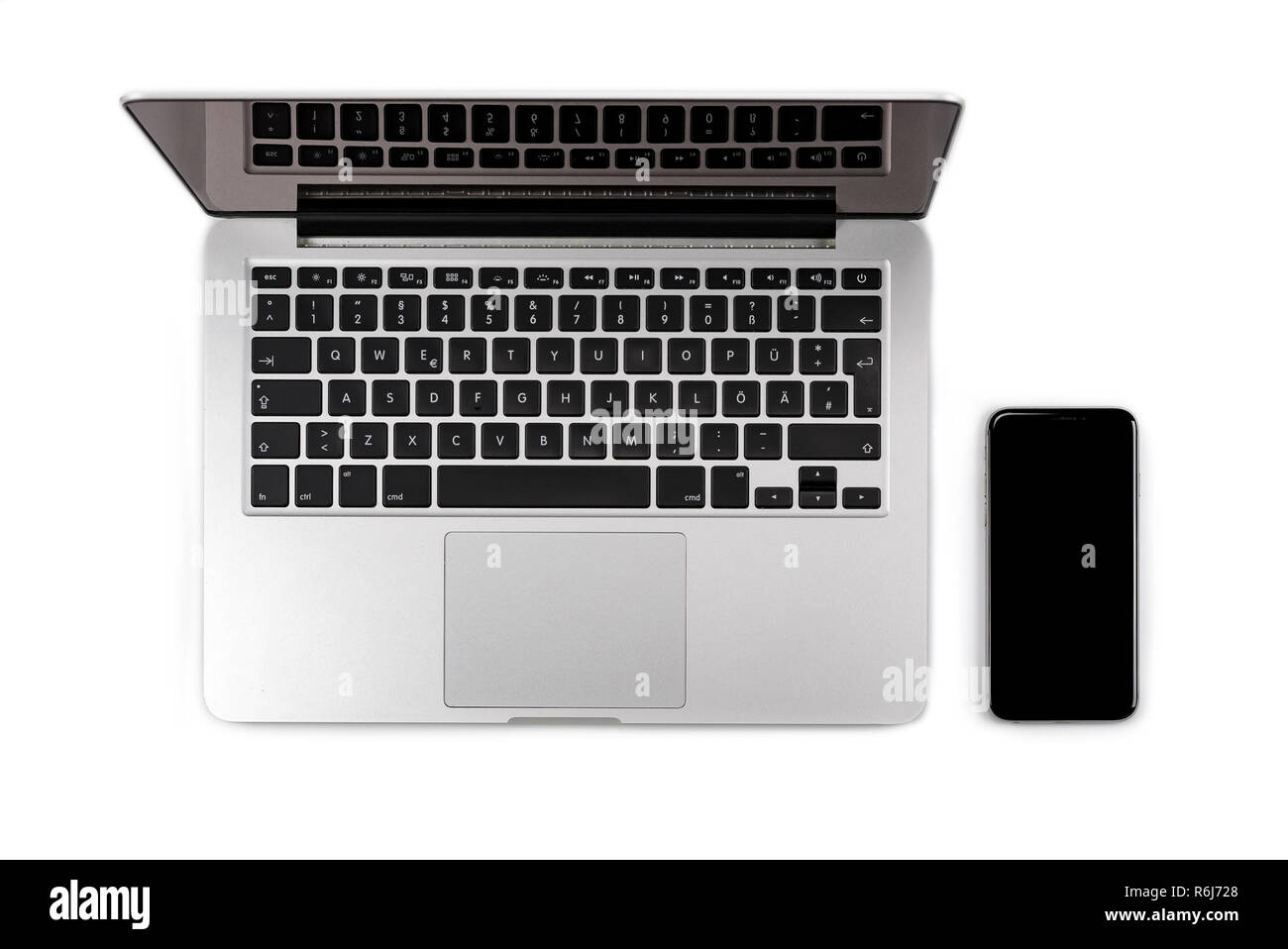 Top view of modern retina laptop with smartphone, isolated on white ...