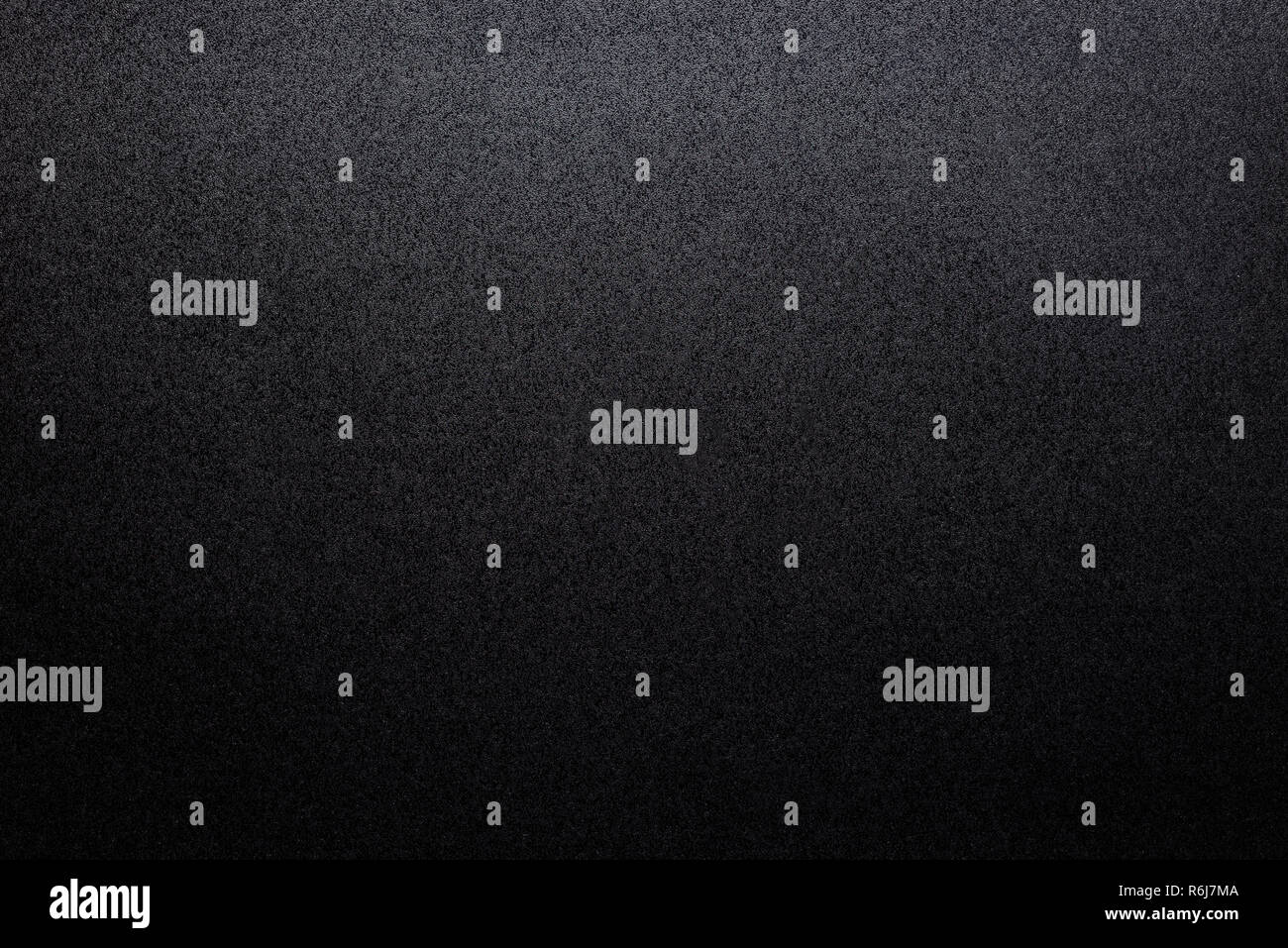 Black, rough textured background lit with dim light Stock Photo - Alamy