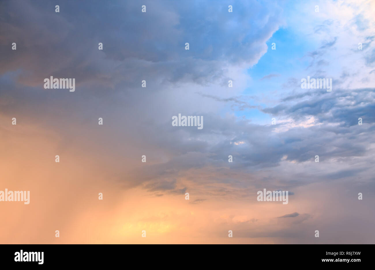 dramatic sunset during the rain with blue sky background Stock Photo ...