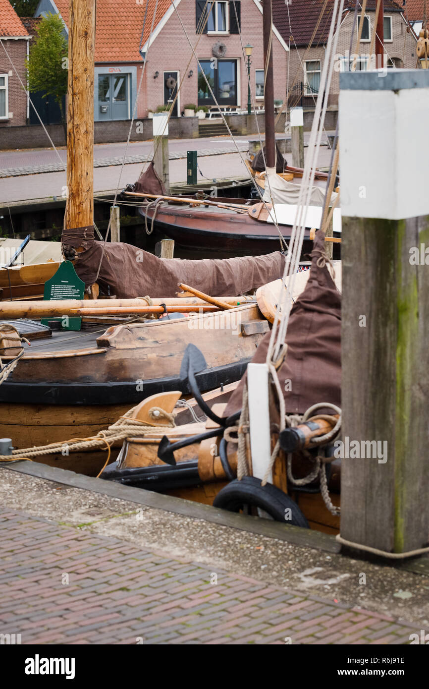 Historical ships and fishing vessels anchored in the harbor of the old ...