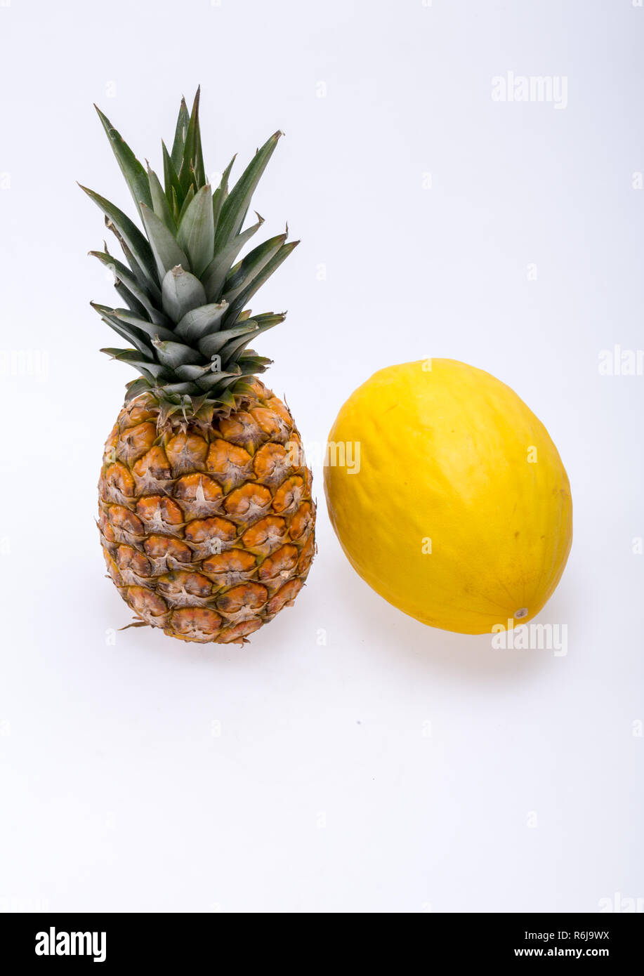 Ripe, fresh pineapple and yellow melon isolated on white background ...