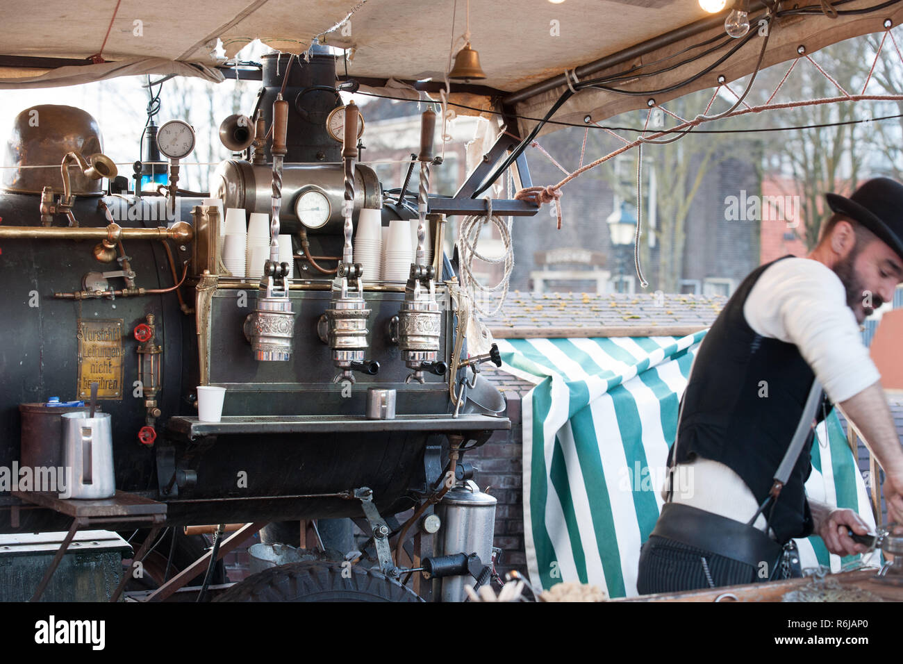 Vintage barista prepare coffee to customer in old style machine with ...