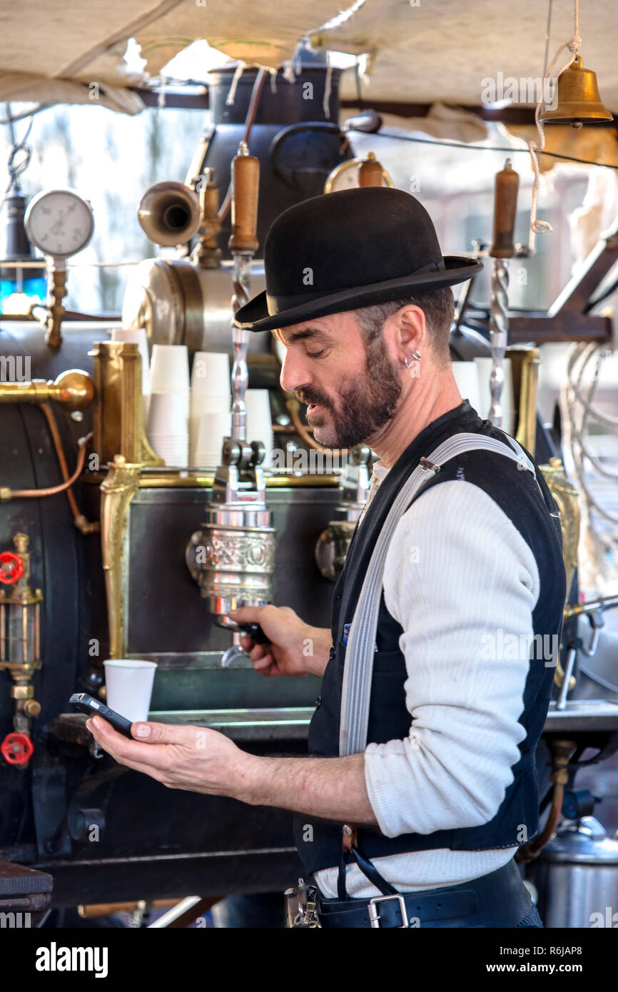 Vintage barista prepare coffee to customer in old style machine with ...