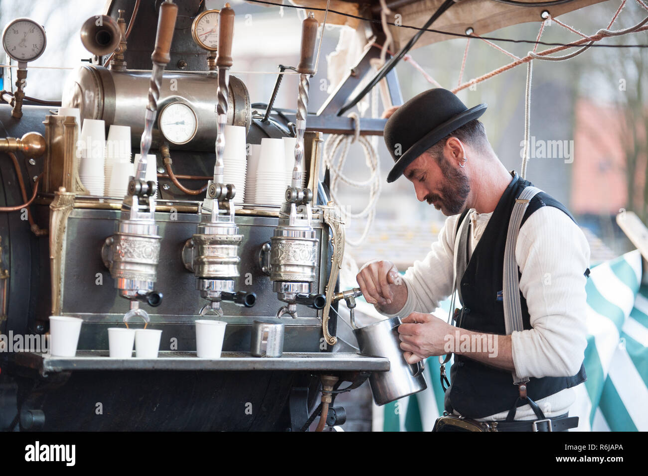 Vintage barista prepare coffee to customer in old style machine with ...