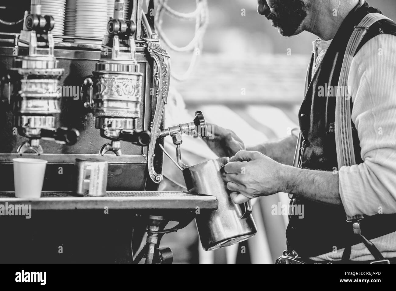 Vintage barista prepare coffee to customer in old style machine with ...