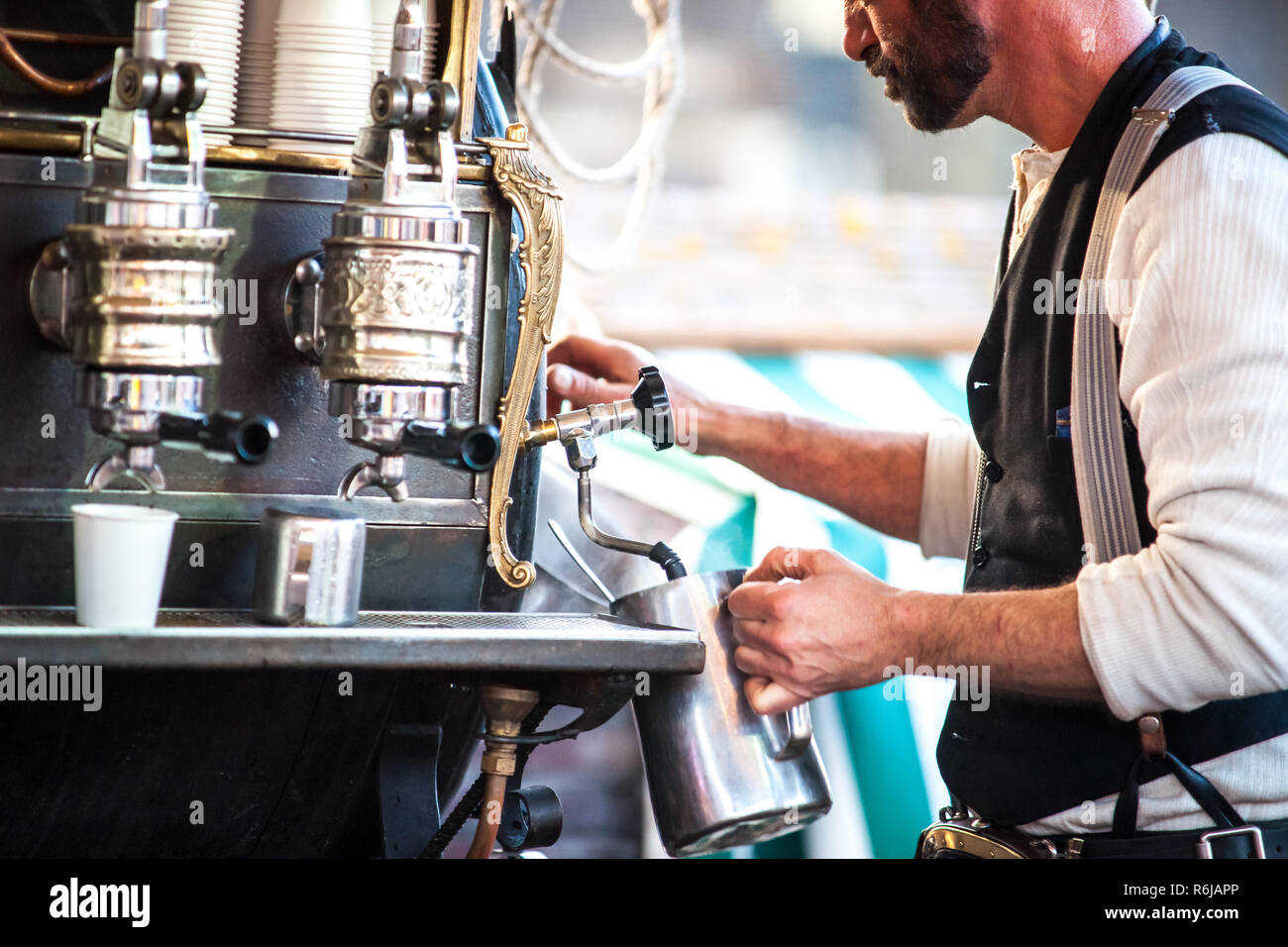 Vintage barista prepare coffee to customer in old style machine with ...