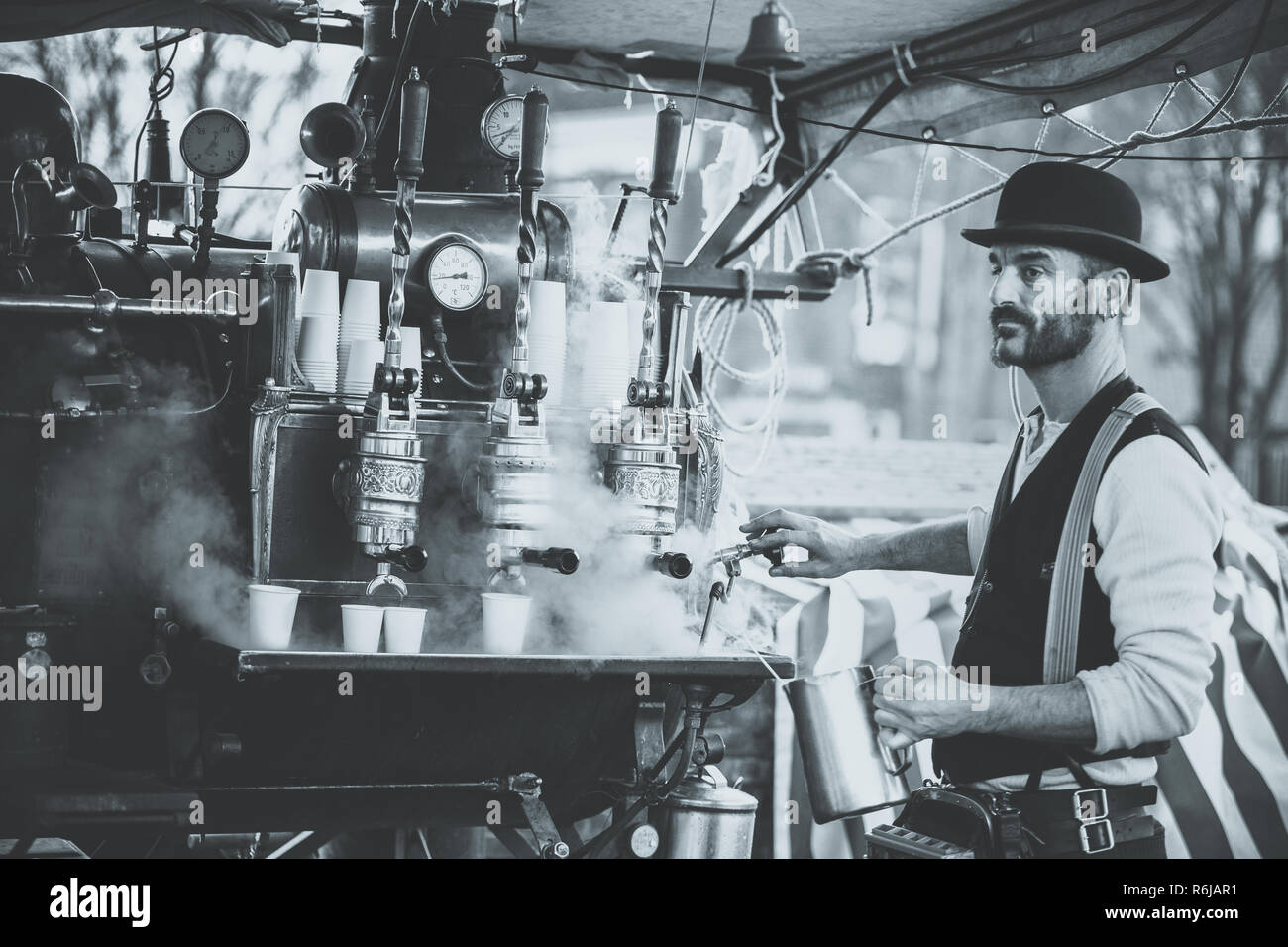 Vintage barista prepare coffee to customer in old style machine with ...