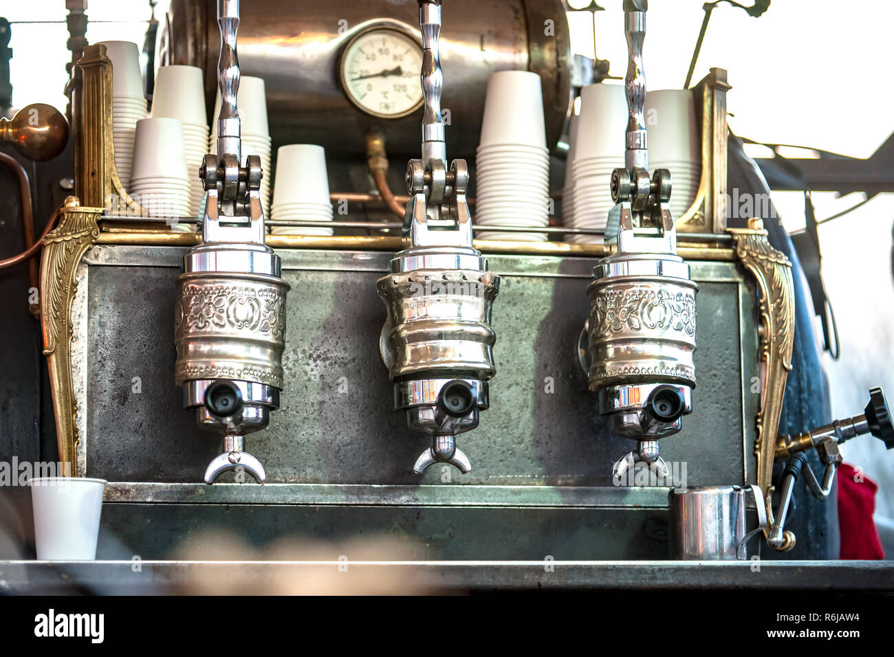 Vintage barista prepare coffee to customer in old style machine with ...