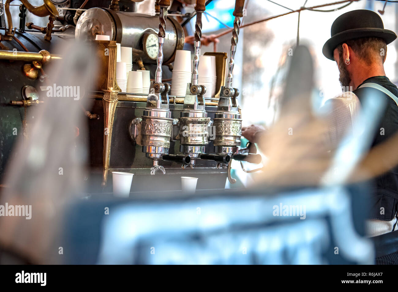 Vintage barista prepare coffee to customer in old style machine with ...