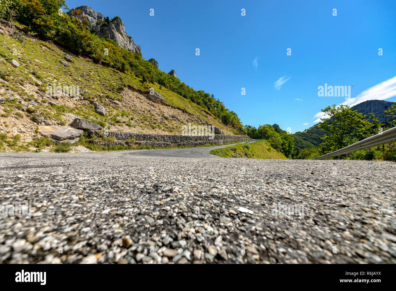 Winding mountain roads with sharp turns and asphalt along steep ...