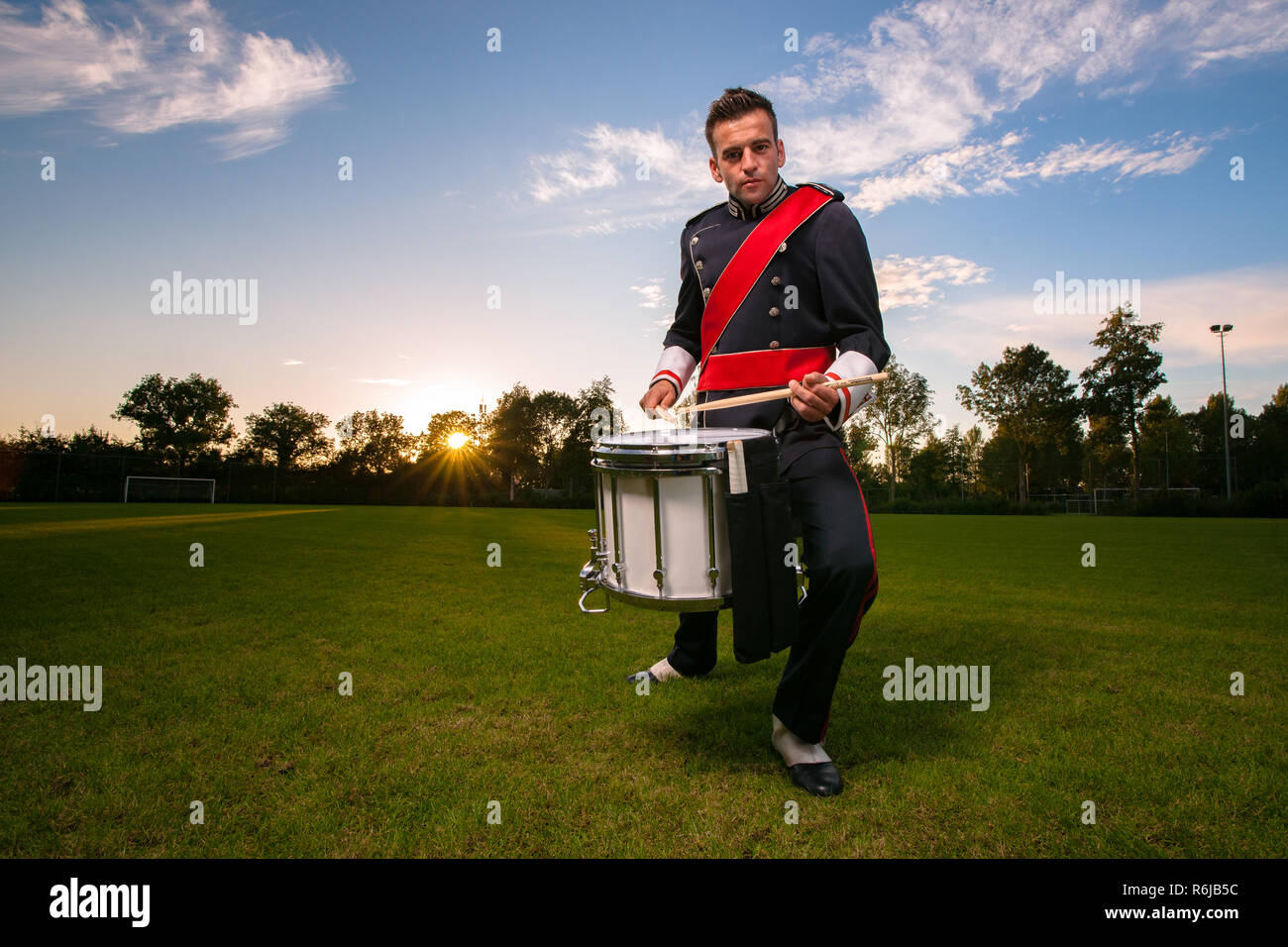 Percussion player or drummer during an outdoor photo shoot with studio ...