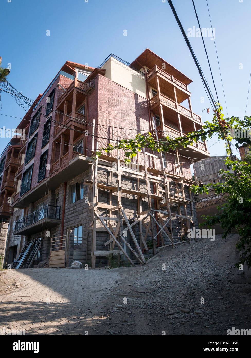 Improvised, rickety scaffolding up the side of a house during building ...