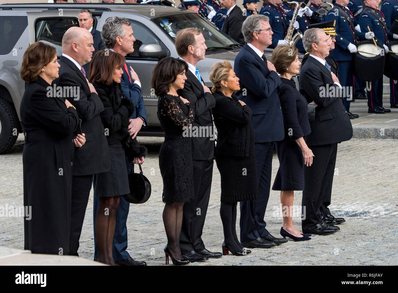 Members of the Bush family salute their father as pallbearers carry the ...