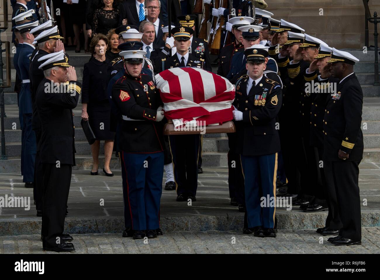 Joint Service pallbearers carry the flag-draped casket of former ...