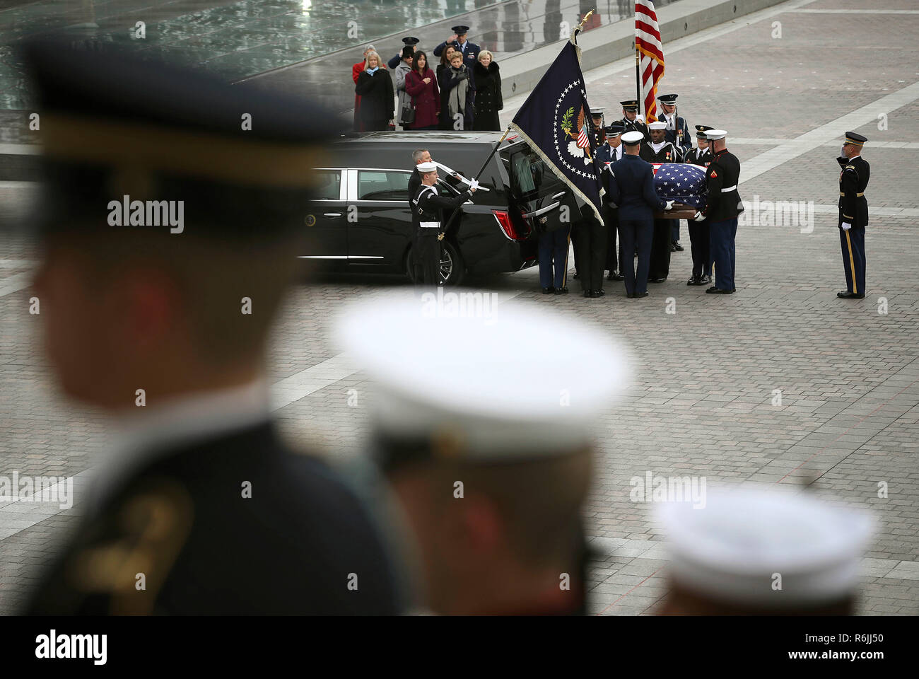 The flag-draped casket of former President George H.W. Bush is placed ...
