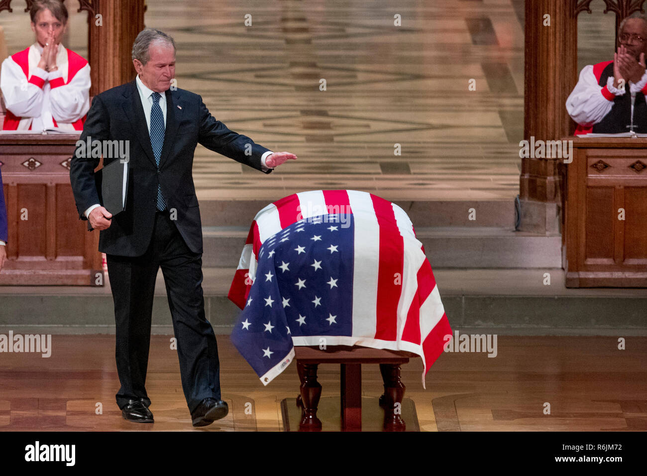An emotional former President George Bush touches the flag-draped ...