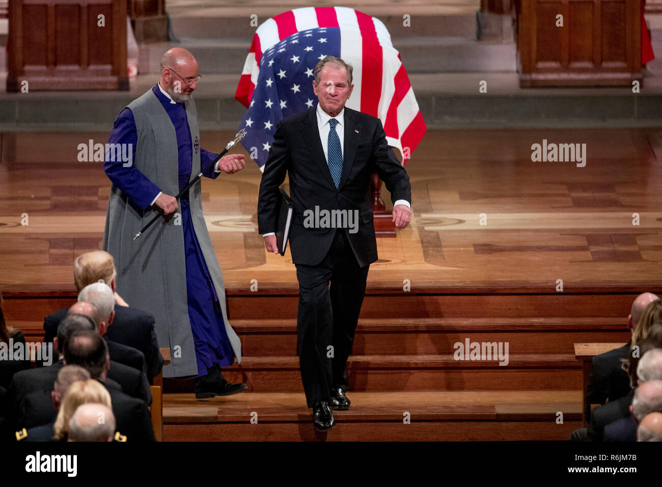 An emotional former President George Bush, sniffs after touching the ...