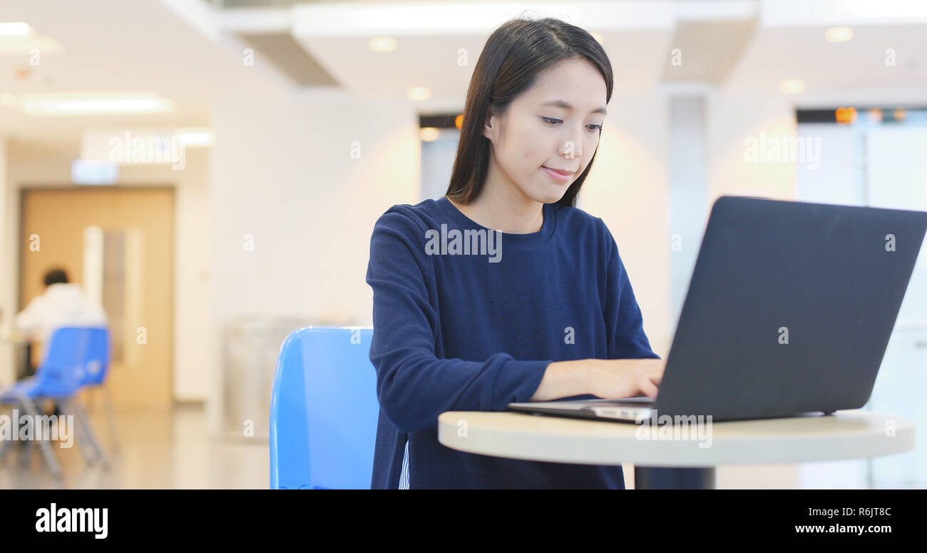 Student working on laptop computer in university campus Stock Photo - Alamy