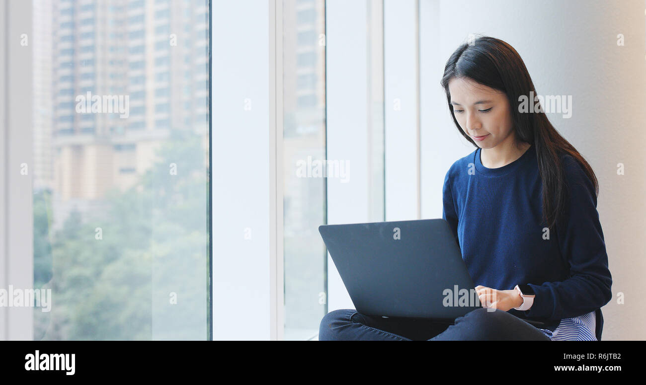 Student doing homework on laptop computer inside university campus ...