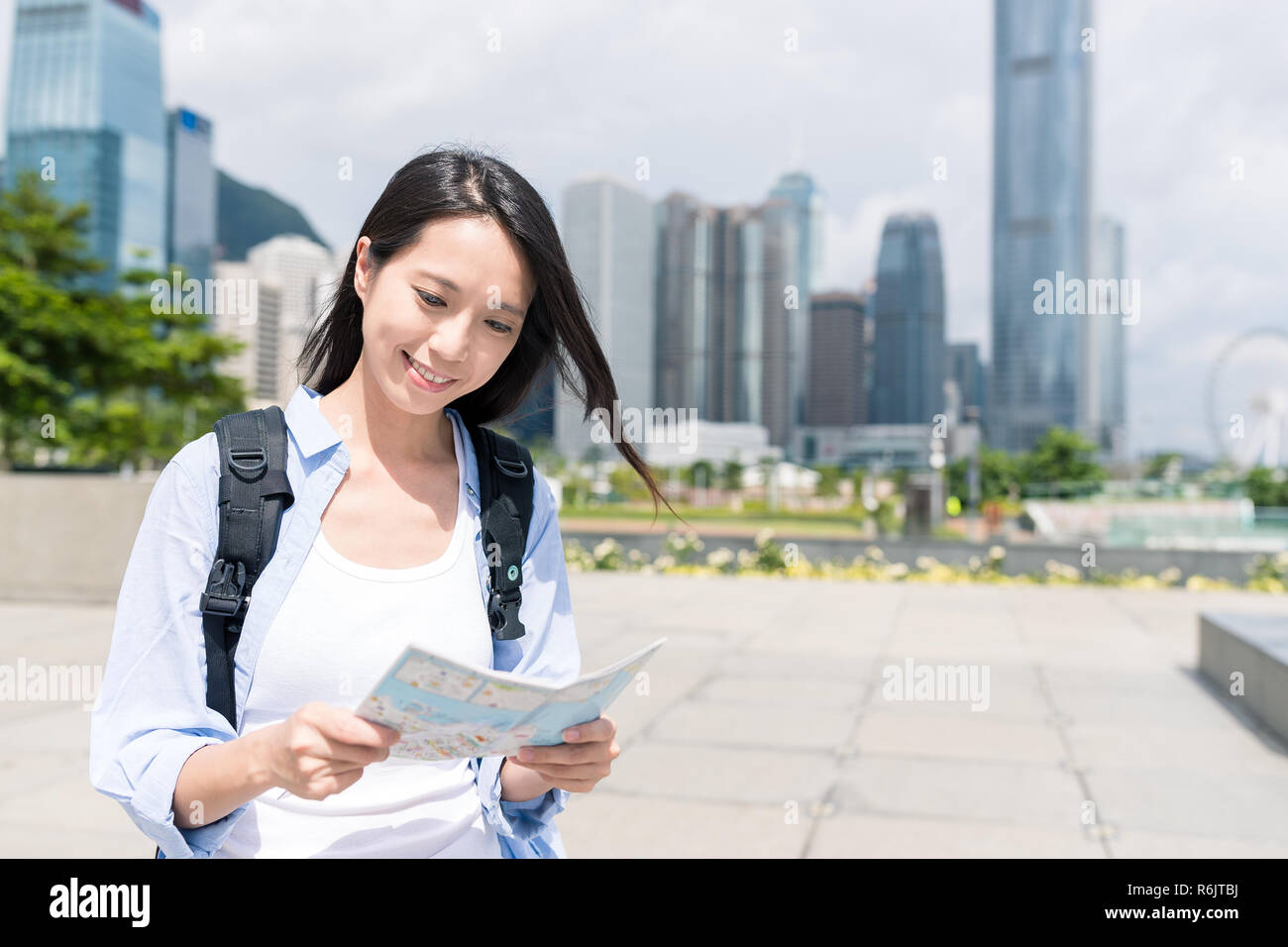 Woman checking on city map in Hong Kong Stock Photo - Alamy