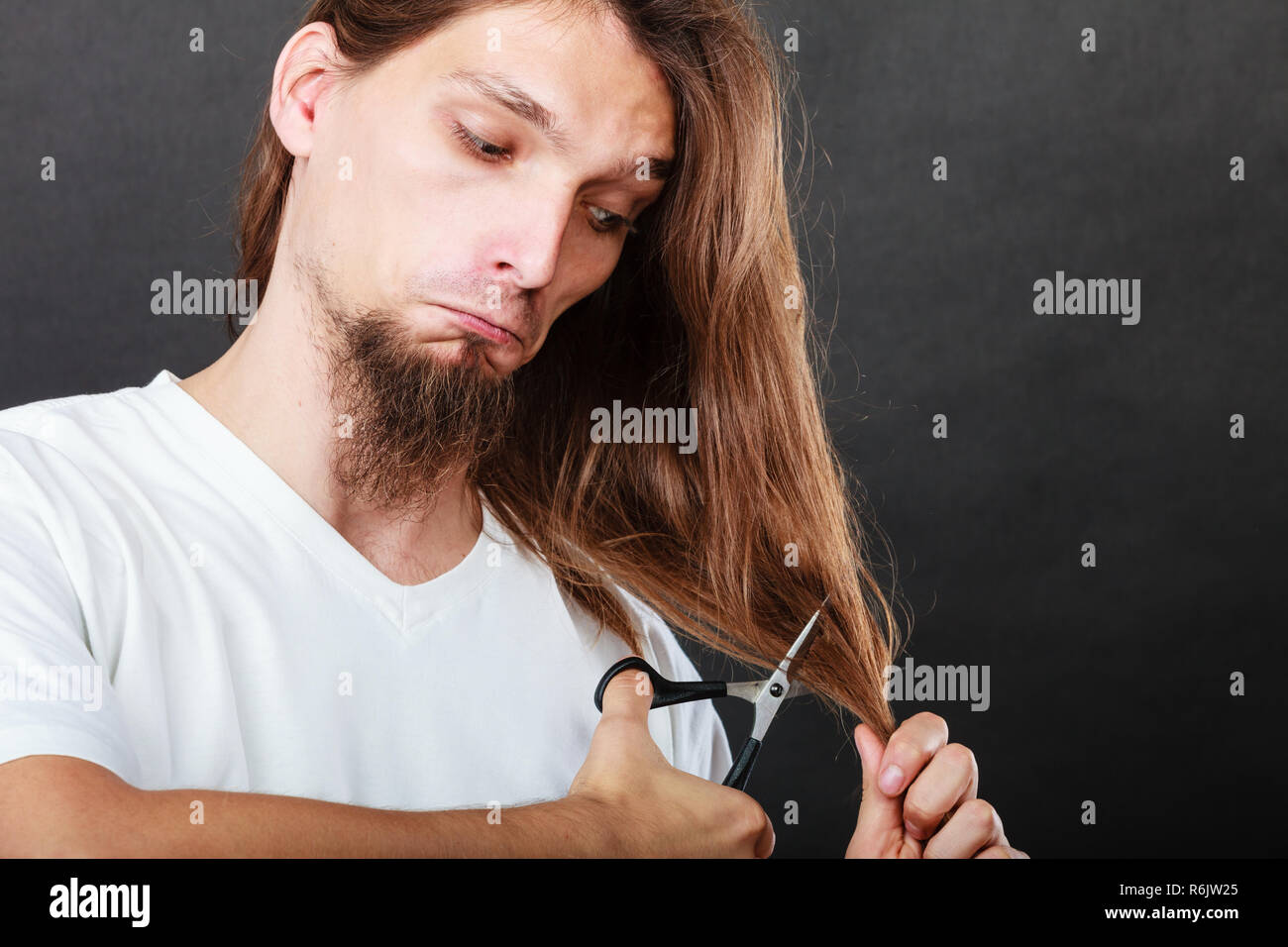 Trim and cut concept. Young handsome man cutting his hair. Change of ...
