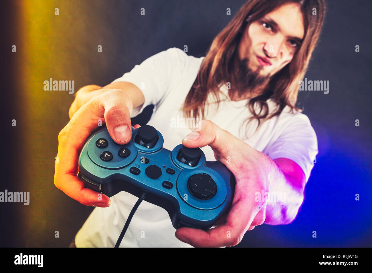 Addiction. Stressed depressed young man playing gaming on pad. Angry ...