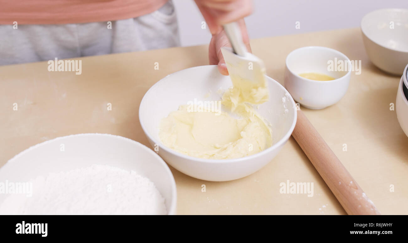 Adding butter into powder Stock Photo - Alamy