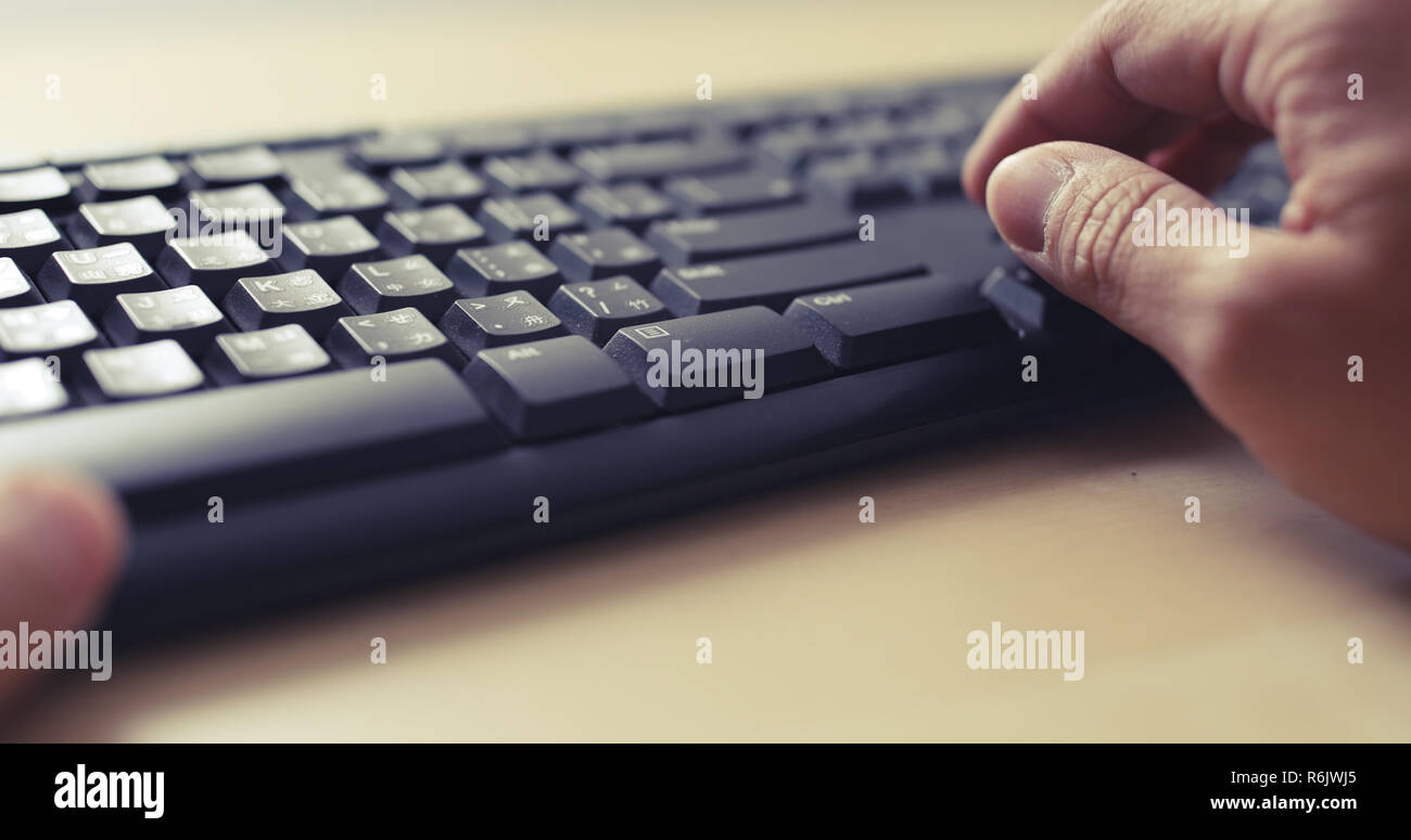 Fingers typing on keyboard Stock Photo - Alamy