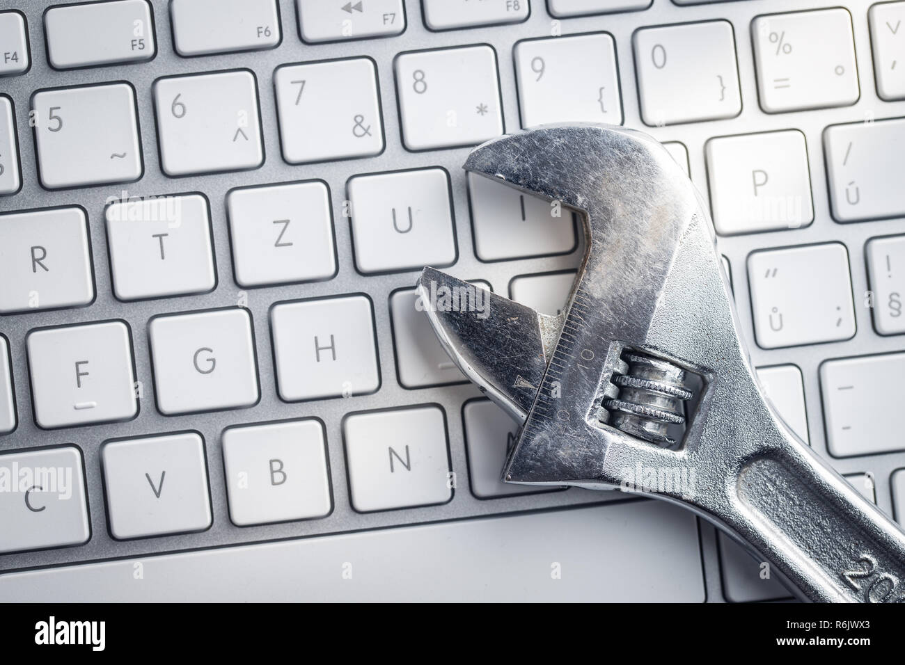 Wrench and computer keyboard. Metallic spanner on keyboard Stock Photo ...