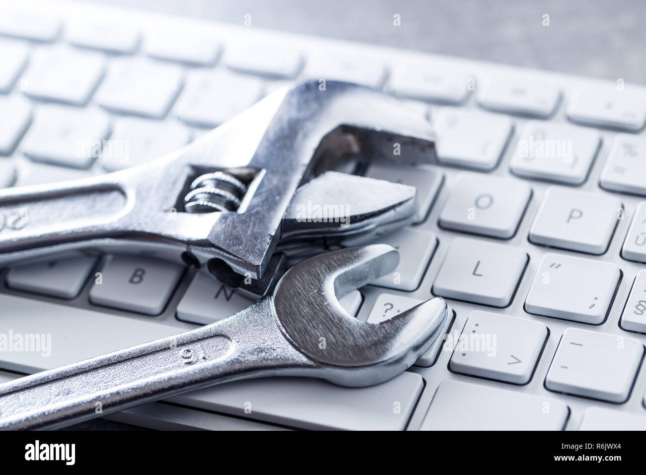 Wrench and computer keyboard. Metallic spanner on keyboard Stock Photo ...