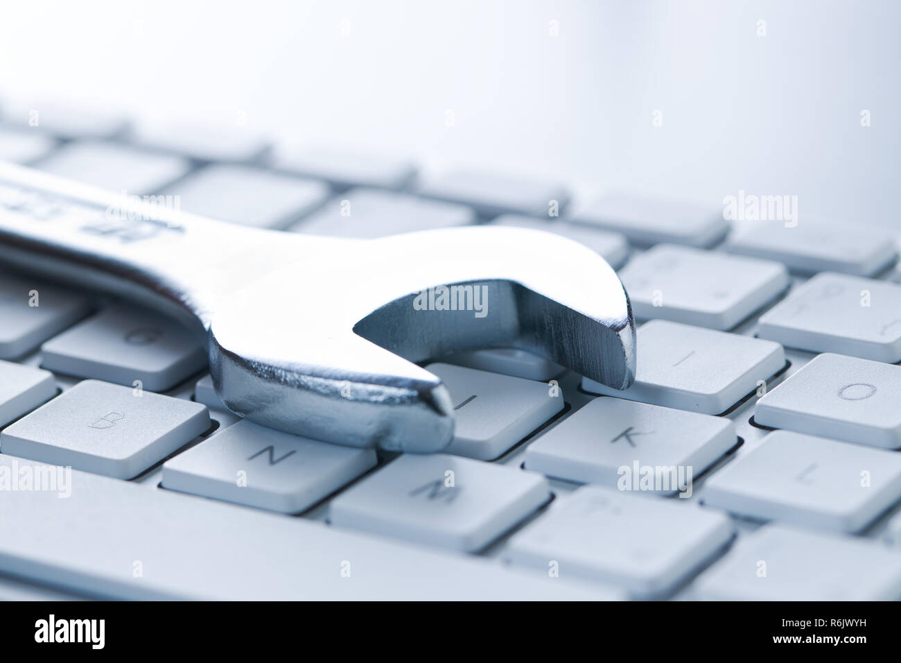 Wrench and computer keyboard. Metallic spanner on keyboard Stock Photo ...