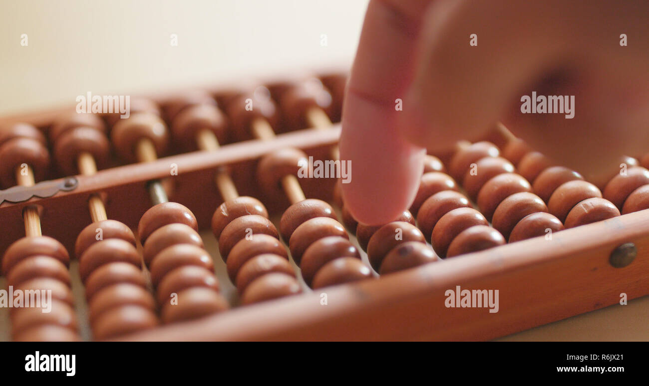 Counting on abacus Stock Photo - Alamy