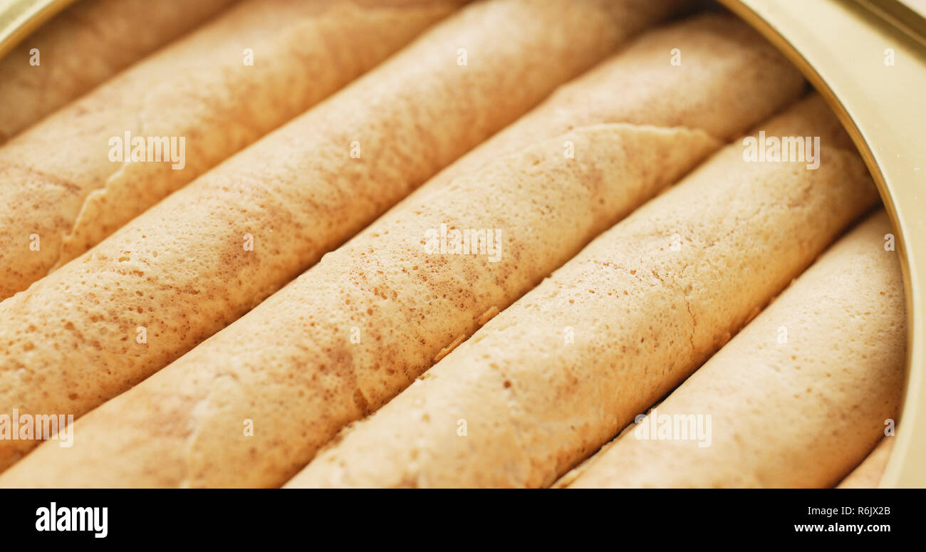 Waffle egg roll inside metal tin can Stock Photo - Alamy