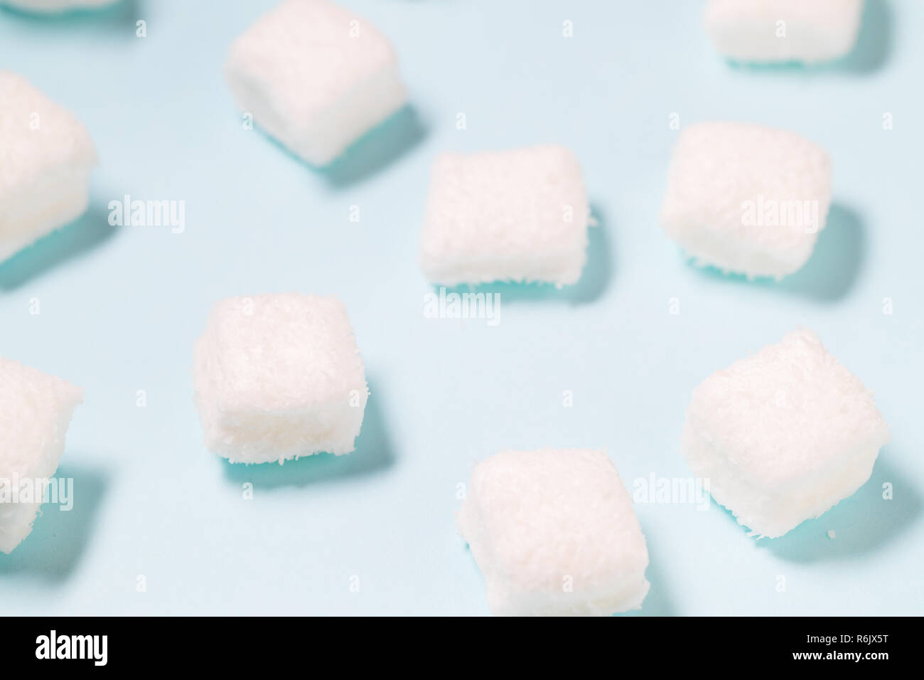 Marshmallow candy on blue background Stock Photo - Alamy