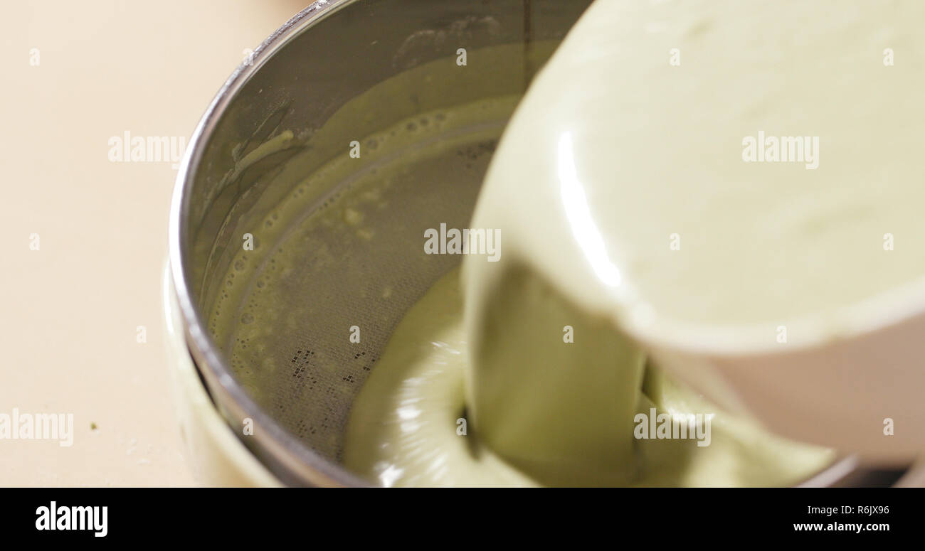 Pouring mixing on sieve Stock Photo - Alamy