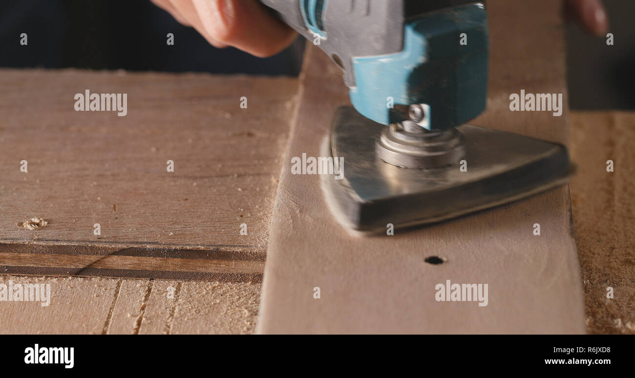 Wood grinder by electric hand router Stock Photo - Alamy