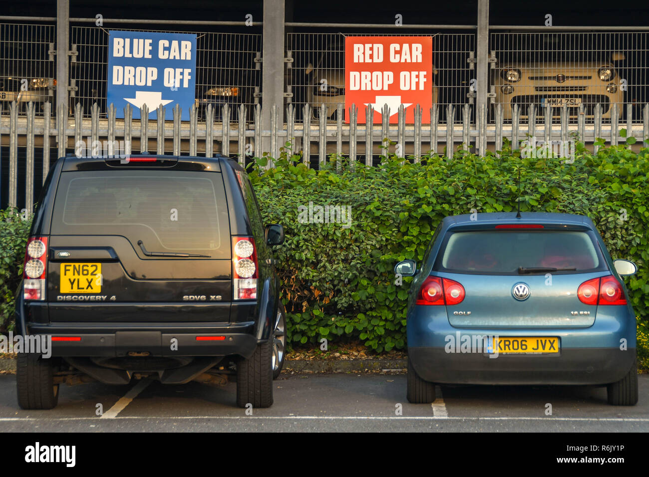 LONDON, ENGLAND - MAY 2018: Coloured signs on the fence of a parking ...
