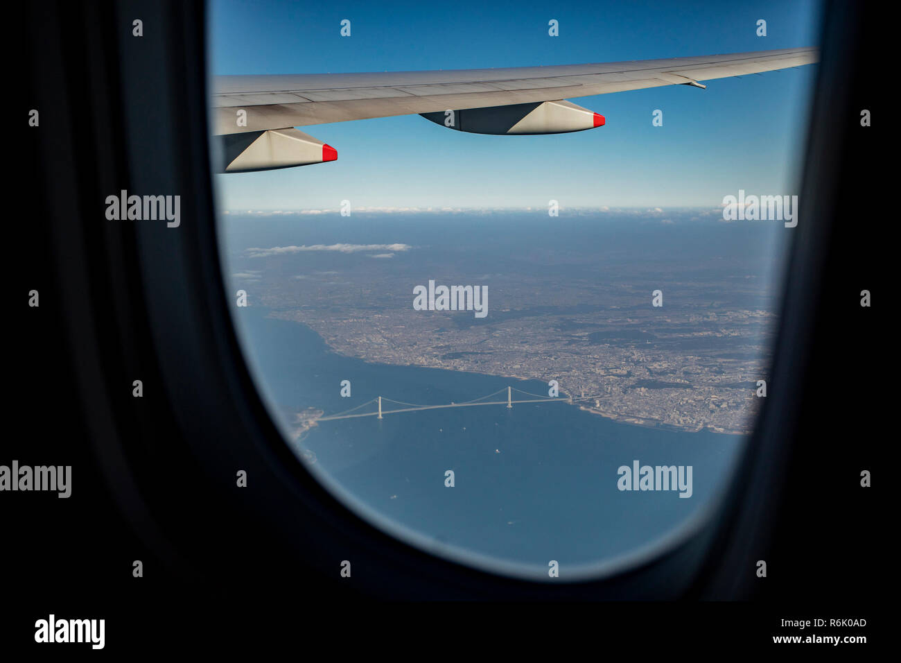 aerial view from plane window over Akashi-Kaikyo Bridge crossing osaka ...