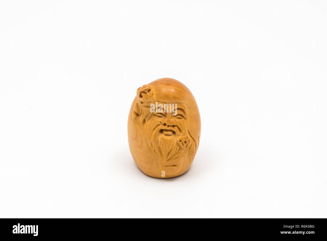 Small oriental wooden statuette Stock Photo - Alamy