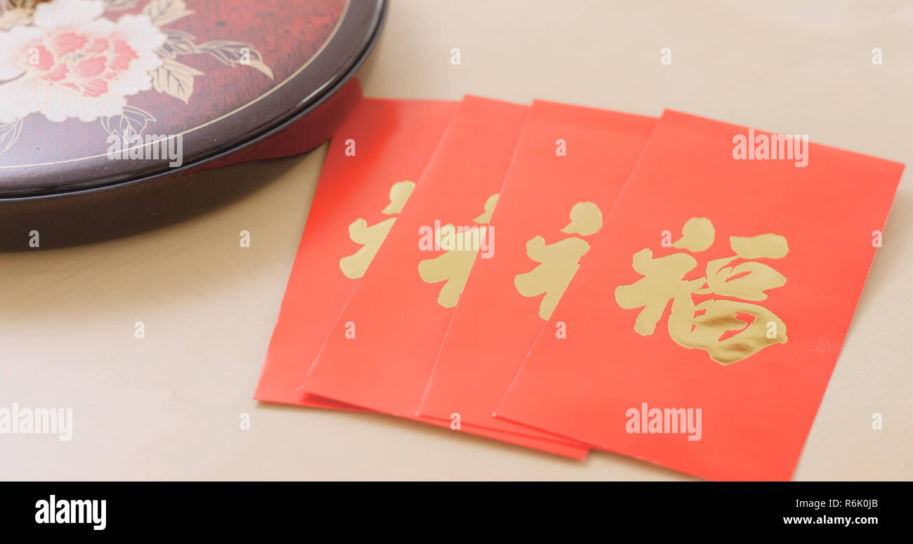 Chinese new year assorted snack box with red pocket, red poacker with a ...