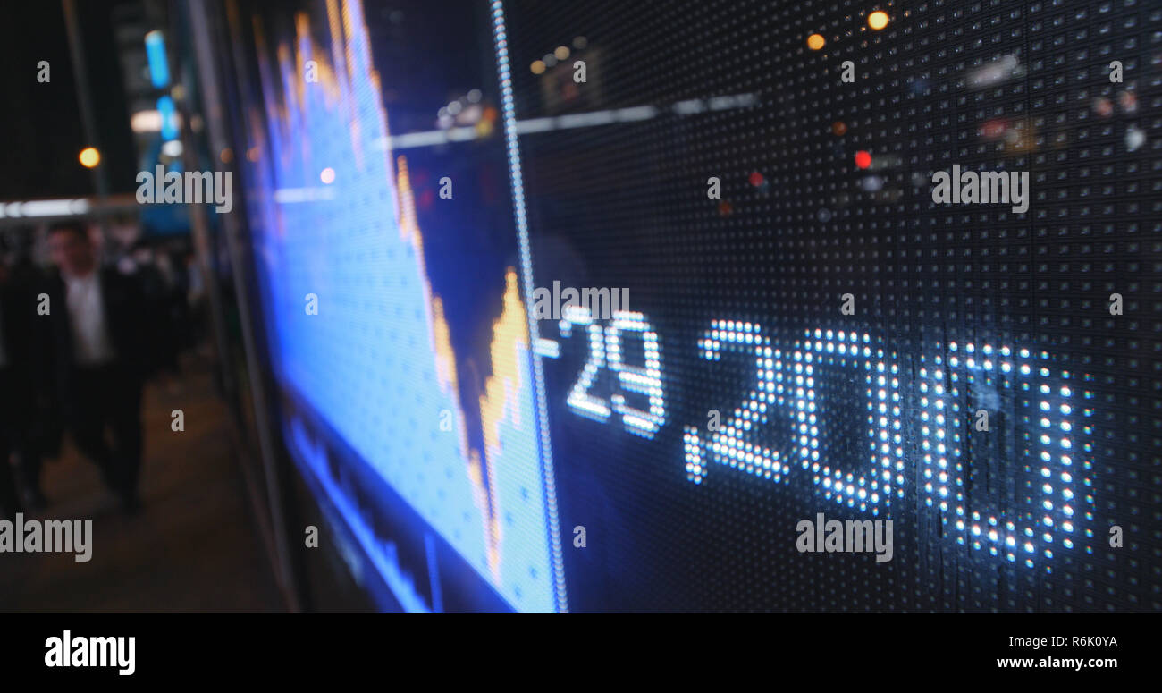 Stock market graph in city at night Stock Photo - Alamy