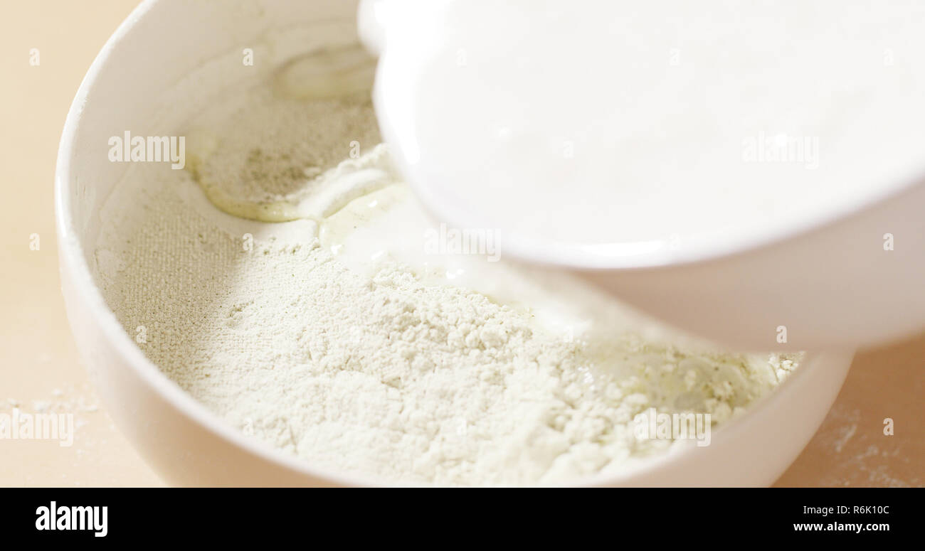 Adding water to the flour Stock Photo - Alamy