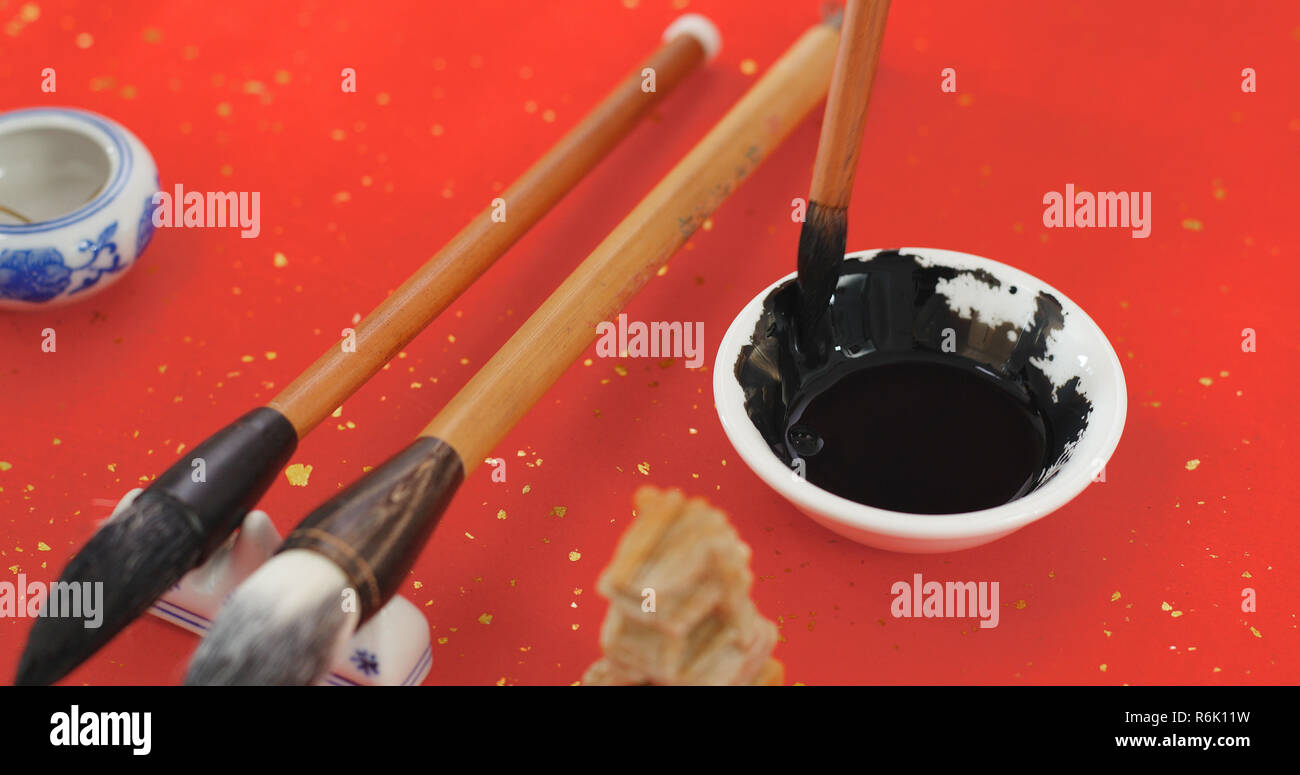 Chinese calligraphy writing tool on red paper Stock Photo - Alamy