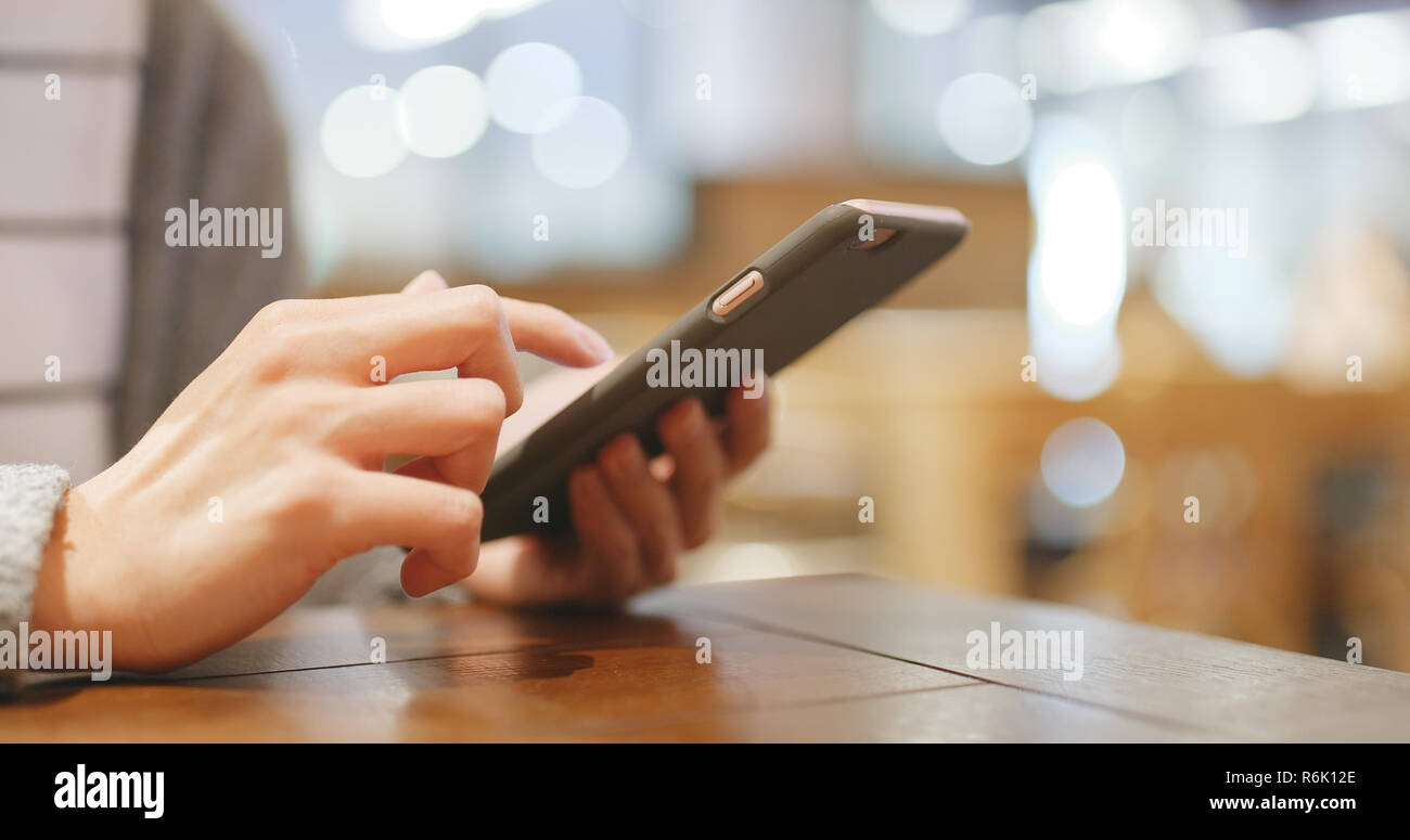Woman use of mobile phone in coffee shop Stock Photo - Alamy