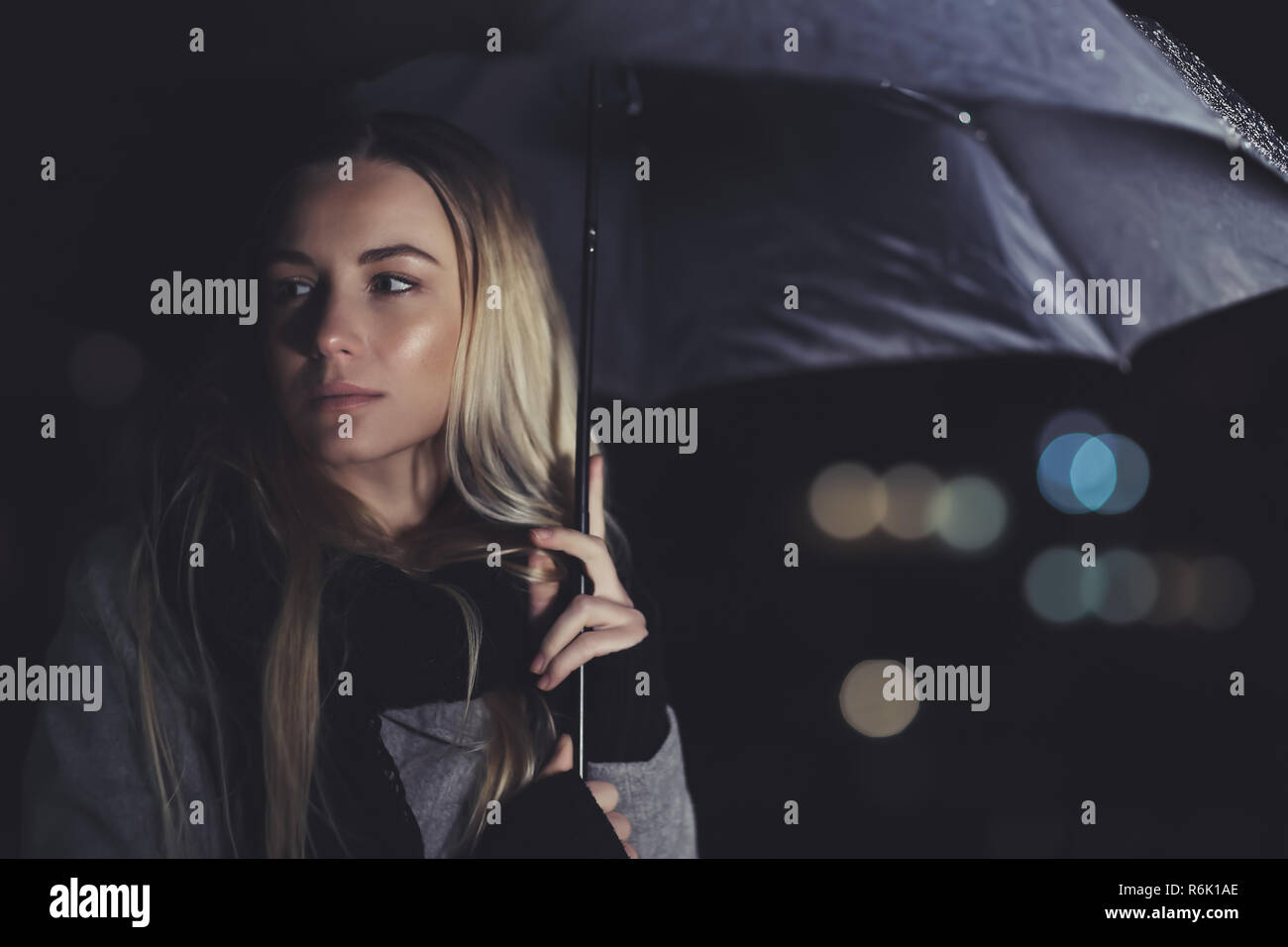 Beautiful sad woman at rainy night Stock Photo - Alamy