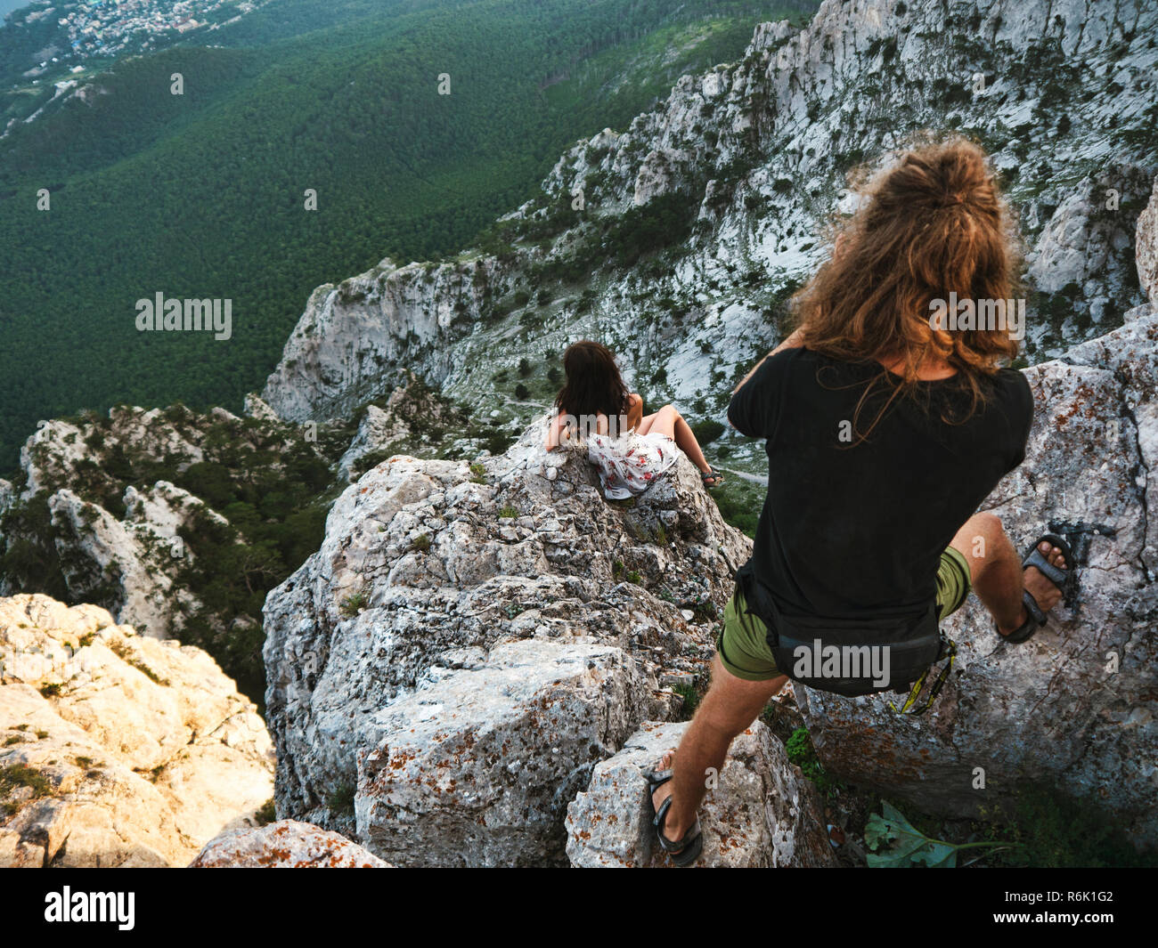 The man is making a photo of girl on the mountain peak. Ai-Petri ...