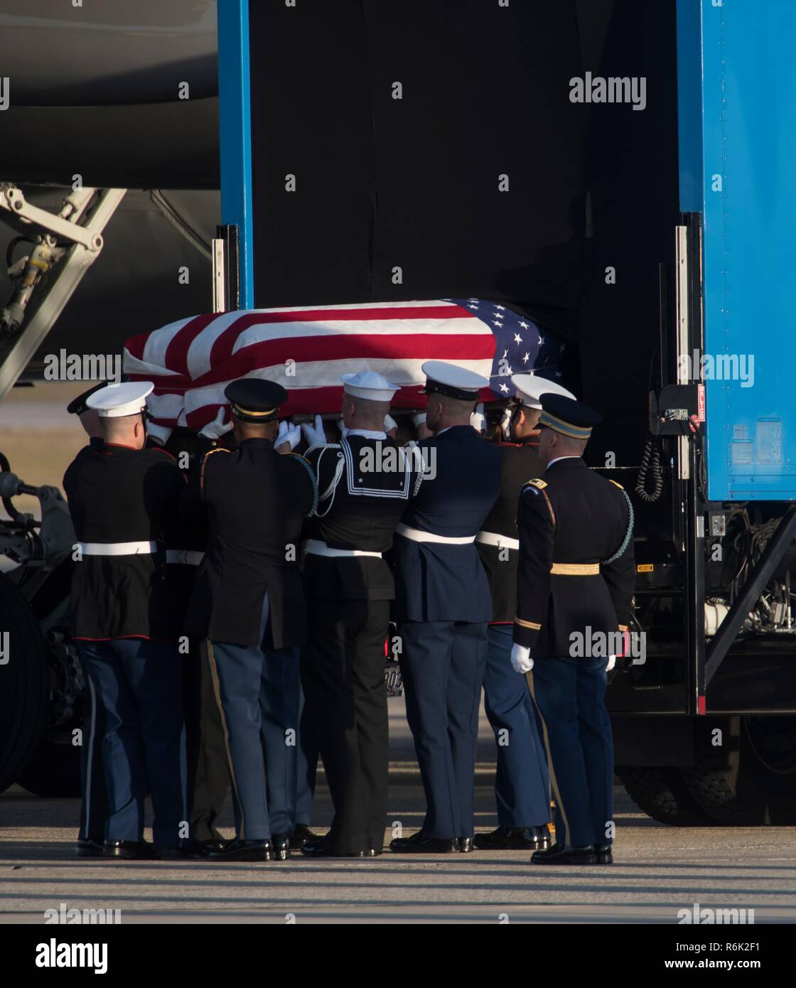Joint Service pallbearers carry the flag-draped casket of former ...
