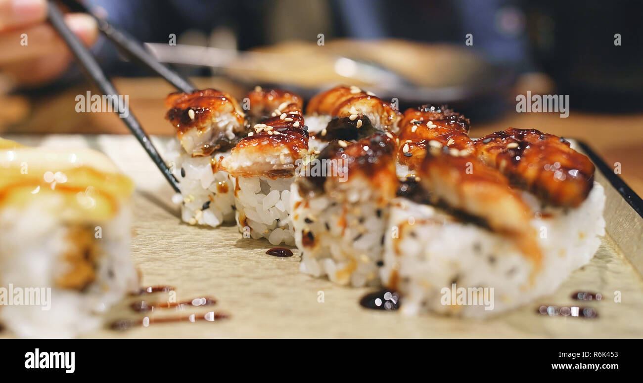 Eating sushi in a japanese restaurant Stock Photo - Alamy