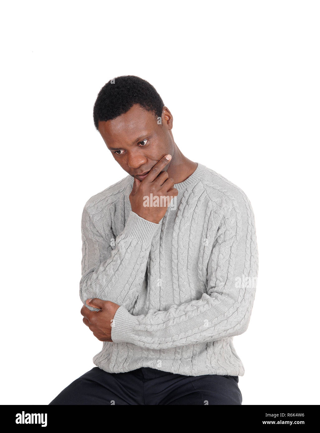 Close up of African man sitting and thinking Stock Photo - Alamy
